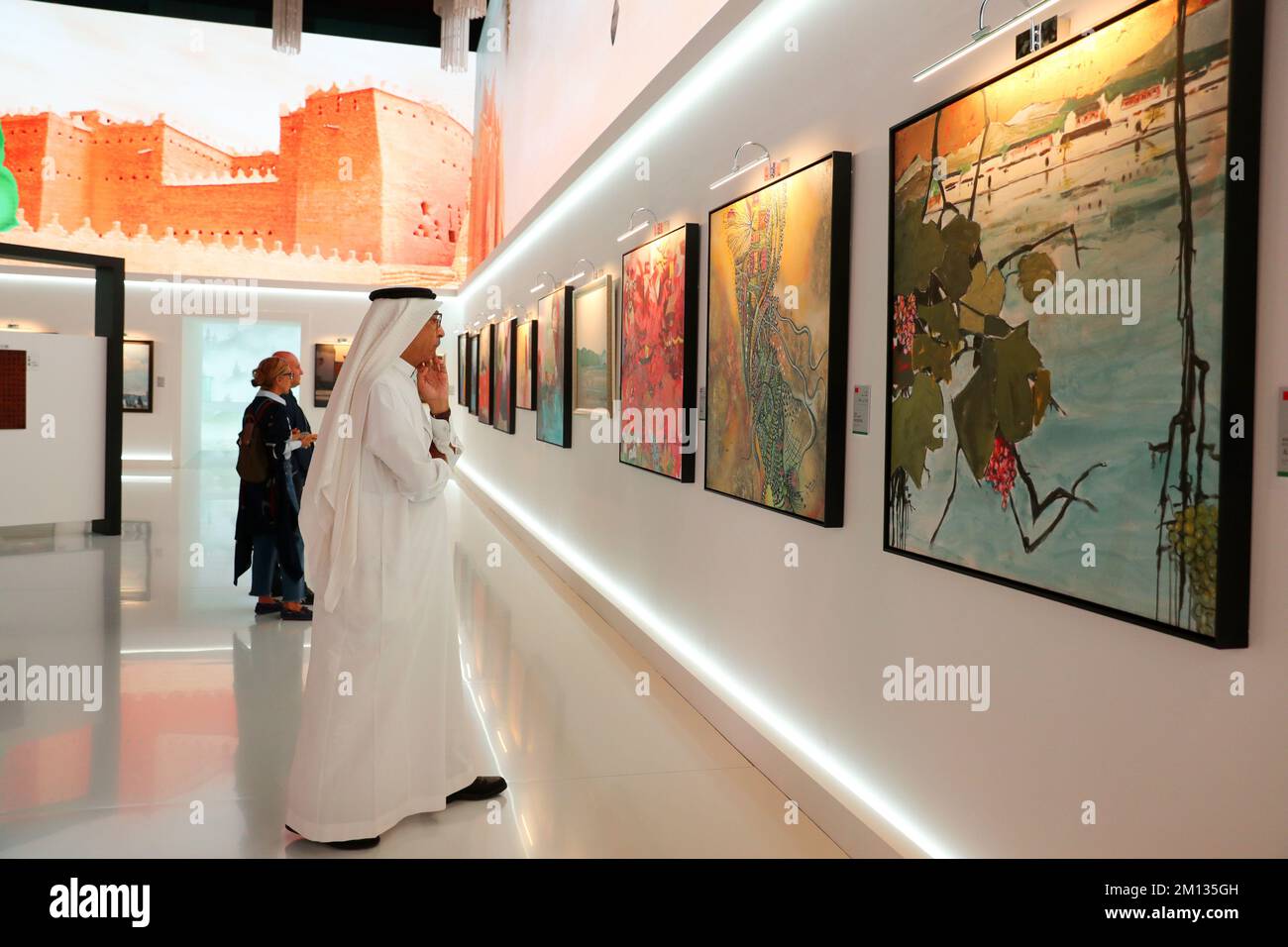 Riyadh, Saudi Arabia. 8th Dec, 2022. People look at paintings at an ...