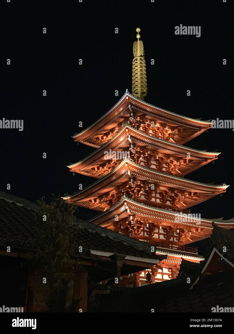 Japanese tall temple structure glowing in the night Stock Photo - Alamy