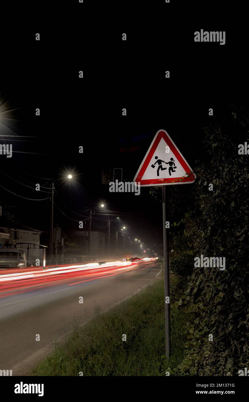 Attention children street sign photographed at night Stock Photo - Alamy