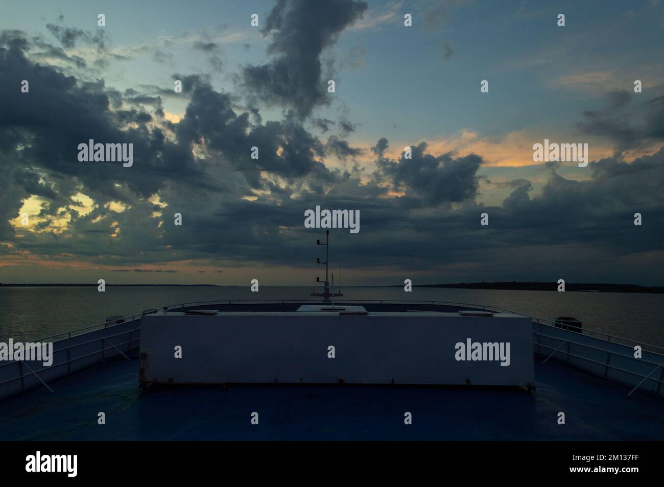 Sun rise on the Amazon river during a night trip on a boat Stock Photo ...