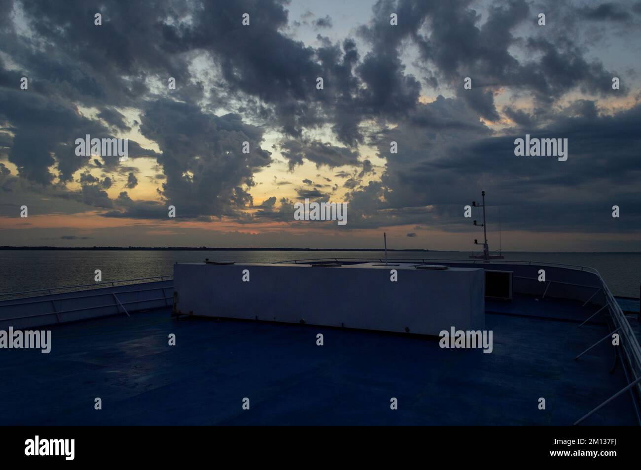 Sun rise on the Amazon river during a night trip on a boat Stock Photo ...