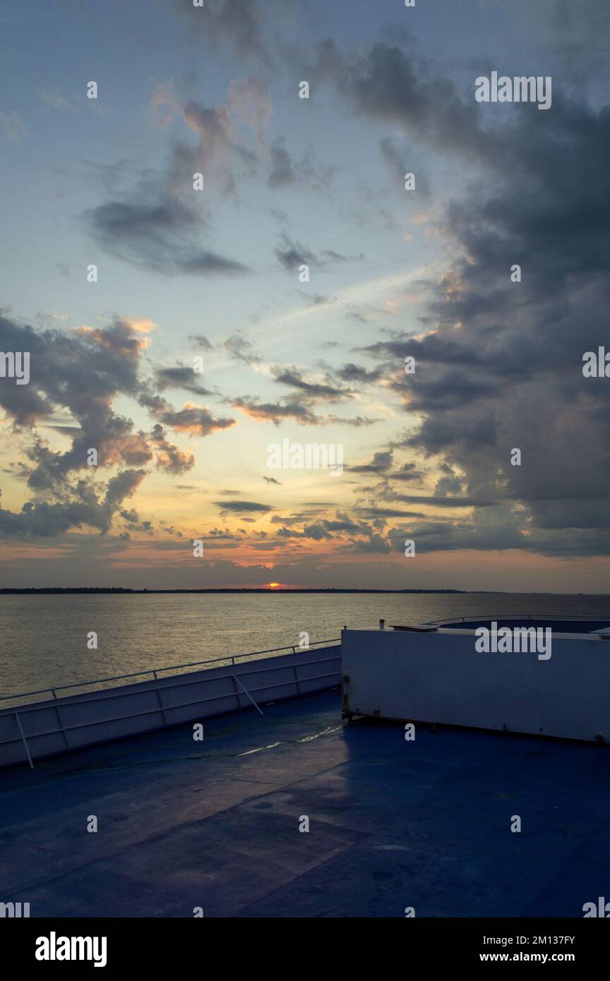 Sun rise on the Amazon river during a night trip on a boat Stock Photo ...