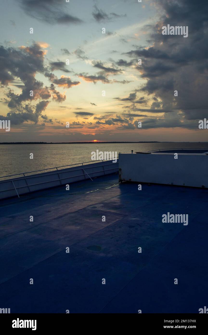 Sun rise on the Amazon river during a night trip on a boat Stock Photo ...