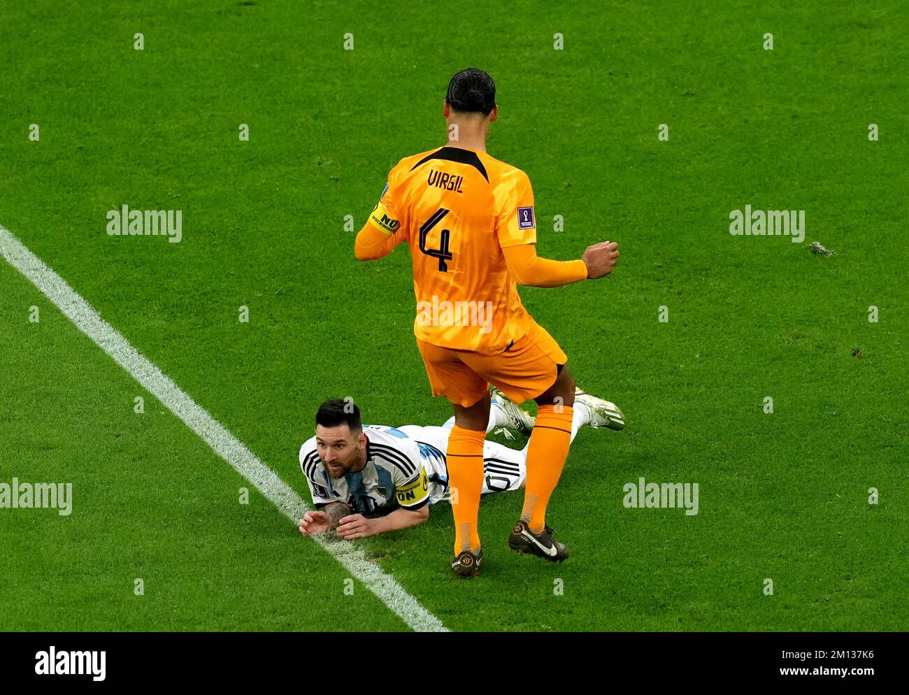 Argentinas Lionel Messi Lies On The Pitch After Being Fouled By Netherlands Virgil Van Dijk