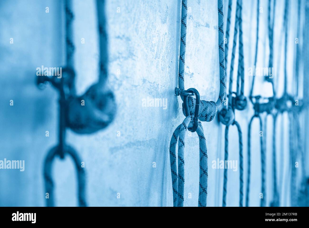Yoga ropes hanging on empty studio wall. Iyengar yoga Stock Photo - Alamy