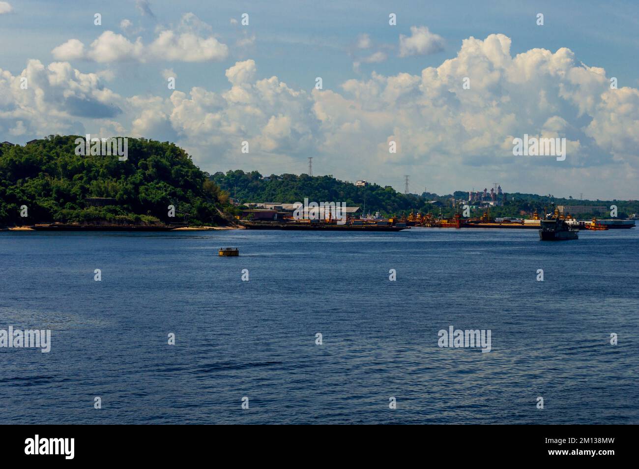 Industrial site on the river banks of Rio Amazonas in Brazil surrounded ...