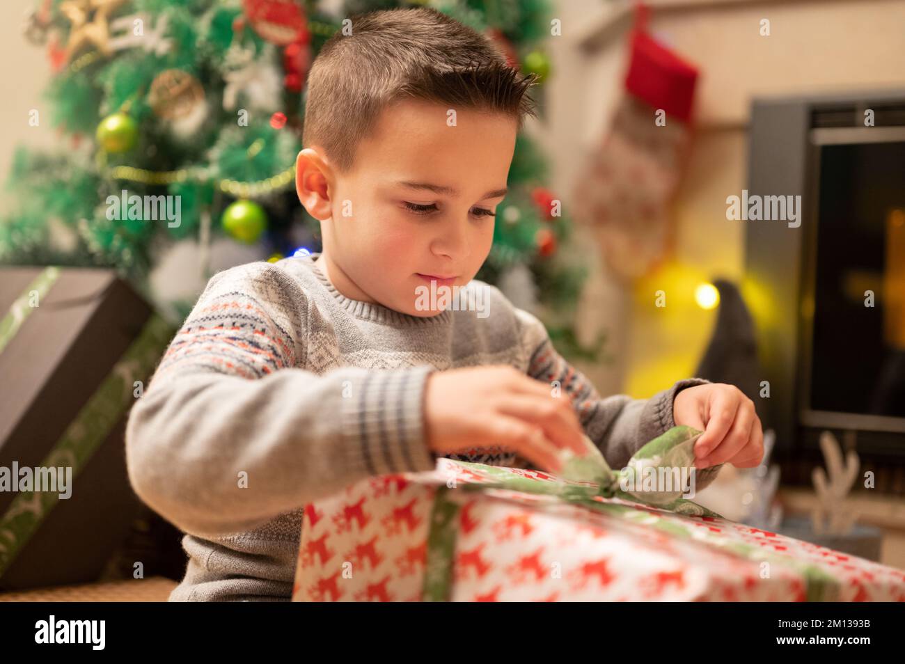 Boy opening christmas present. High quality photography Stock Photo - Alamy