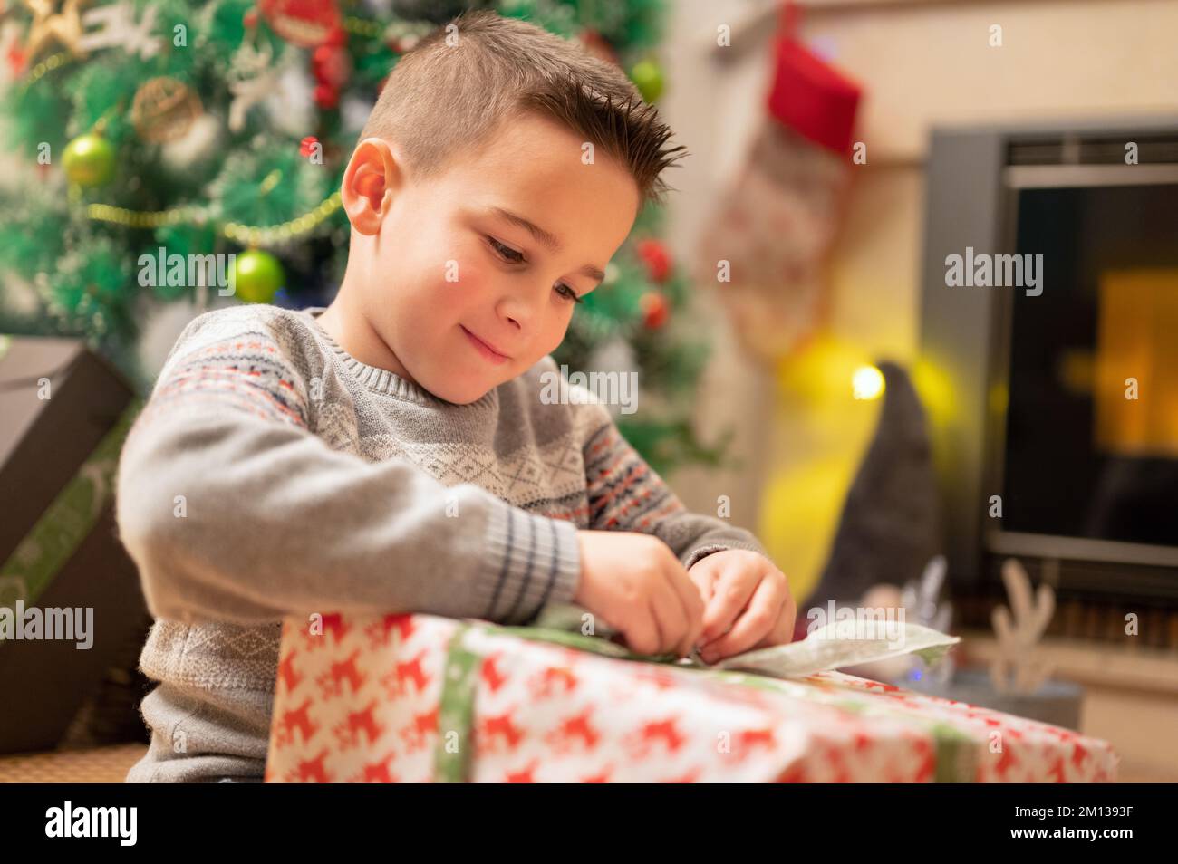 Boy opening christmas present. High quality photography Stock Photo - Alamy