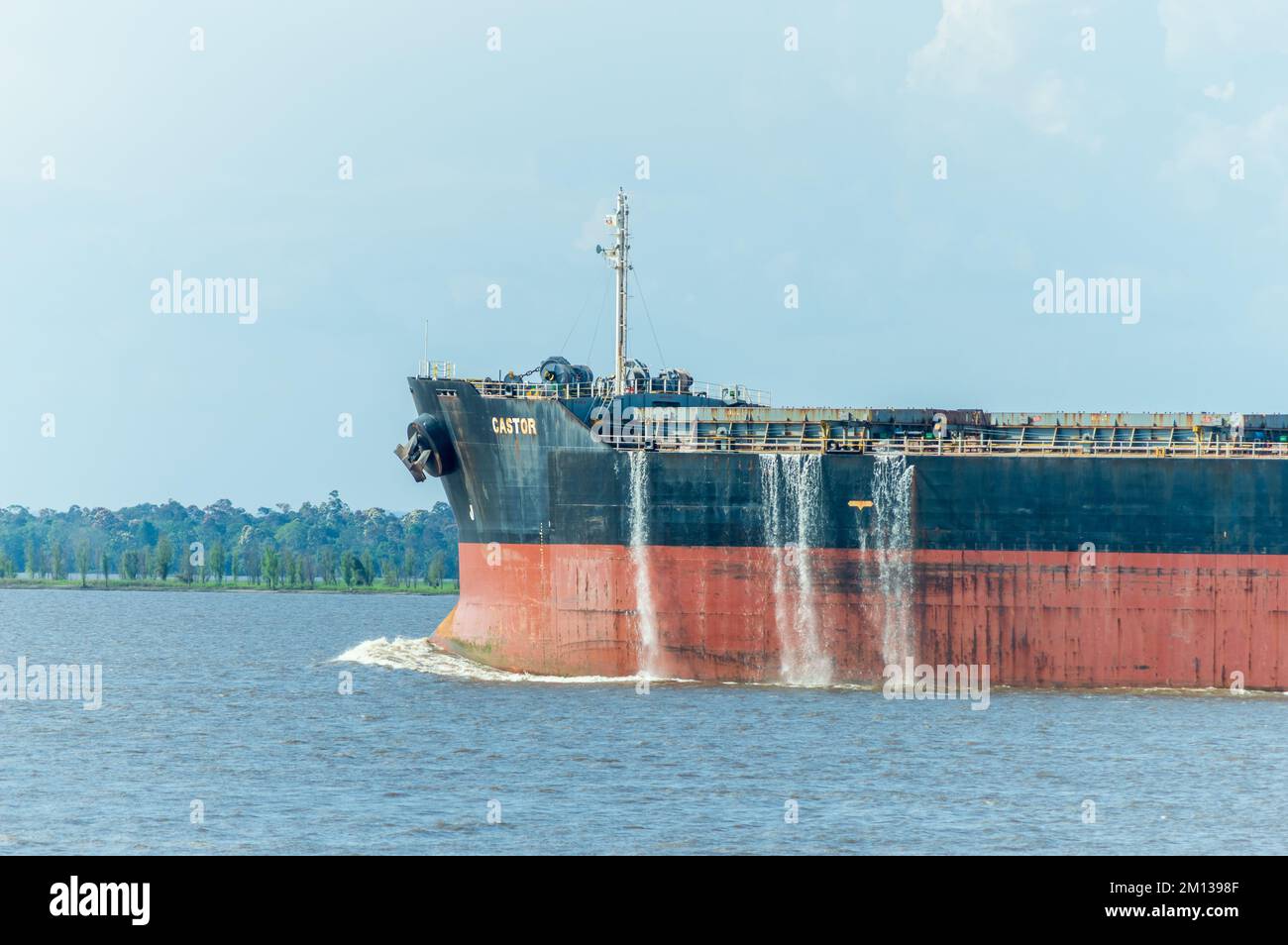 Cargo ships travelling along the Amazonas river in Brazil along the ...