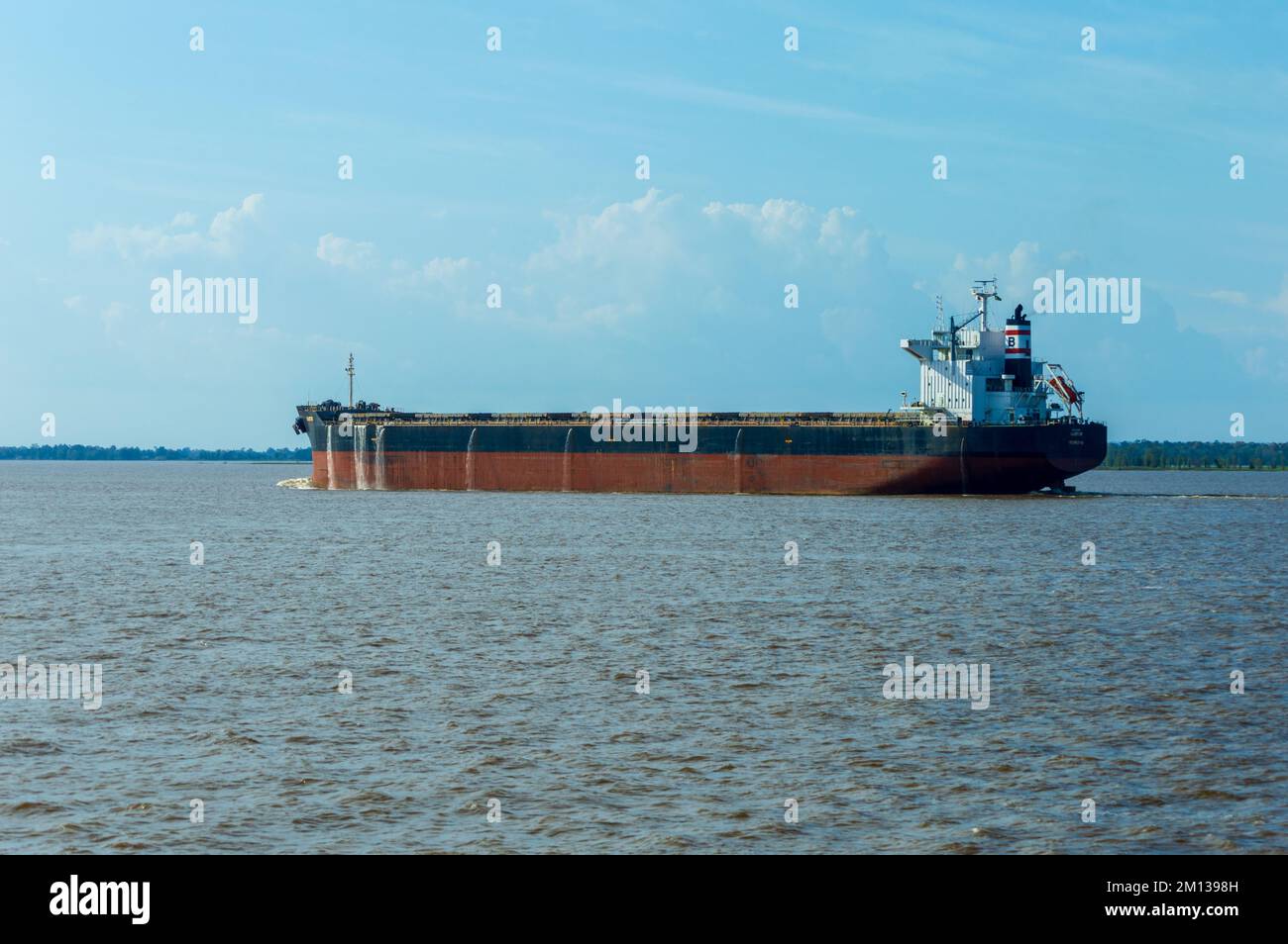 Cargo ships travelling along the Amazonas river in Brazil along the ...
