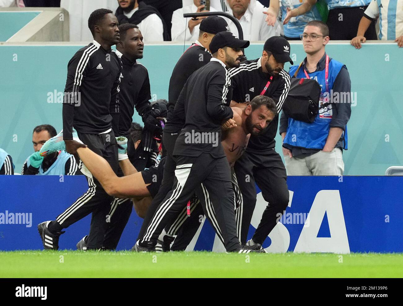 A pitch invader is carried off during the FIFA World Cup Quarter-Final ...