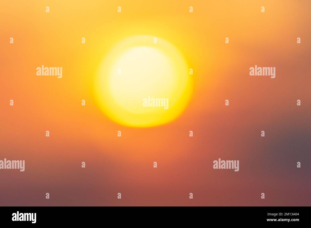 Blurred sun, orange dramatic light Stock Photo - Alamy
