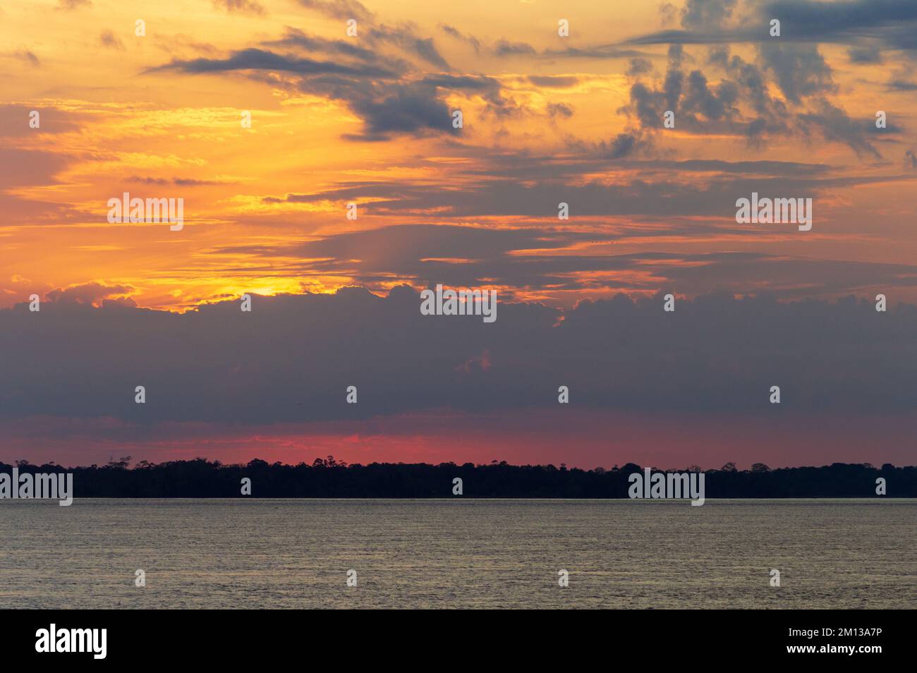 Amazing sunrise on the water of Amazon river in Brazil, nice soft warm ...