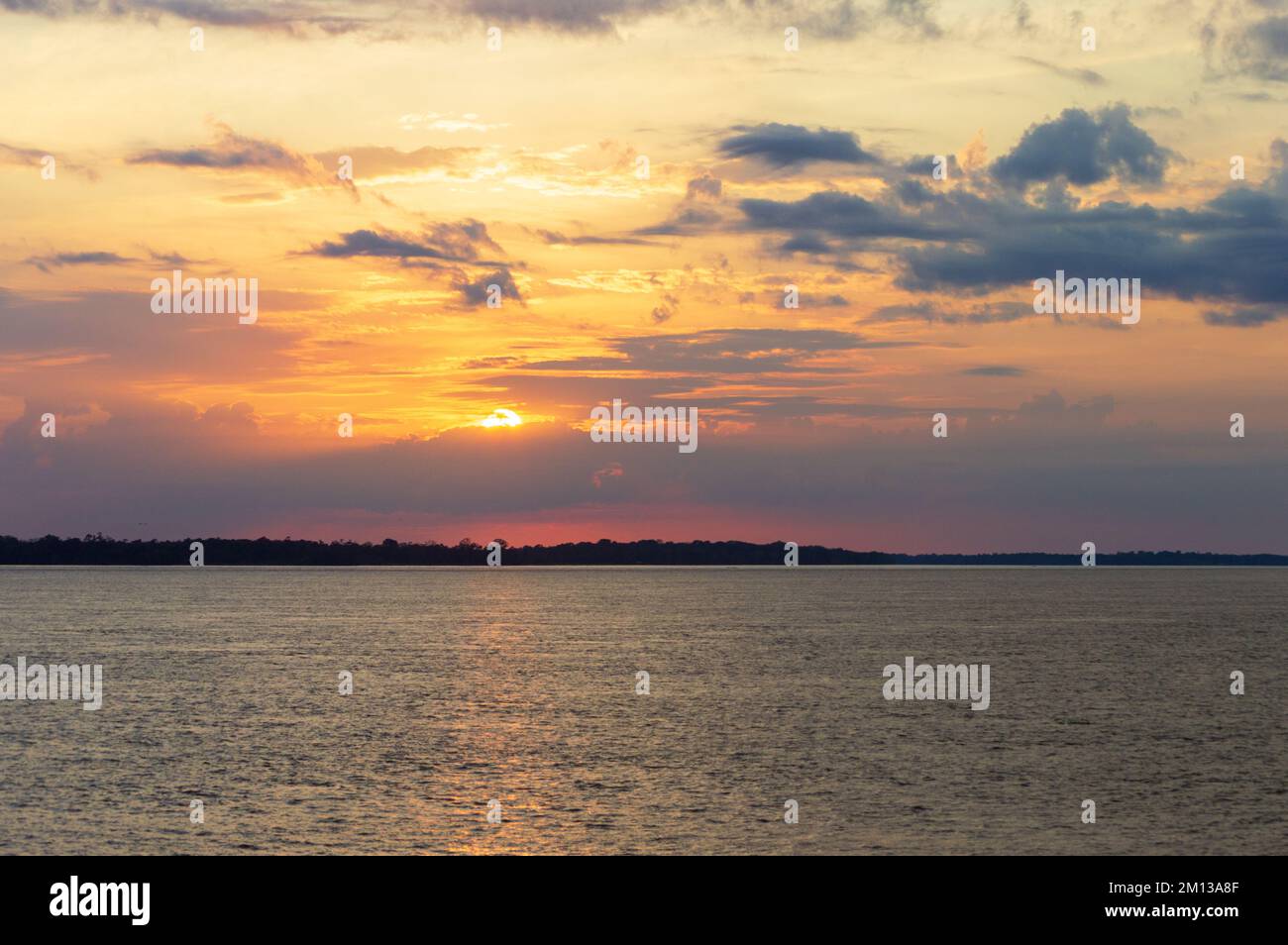 Amazing sunrise on the water of Amazon river in Brazil, nice soft warm ...