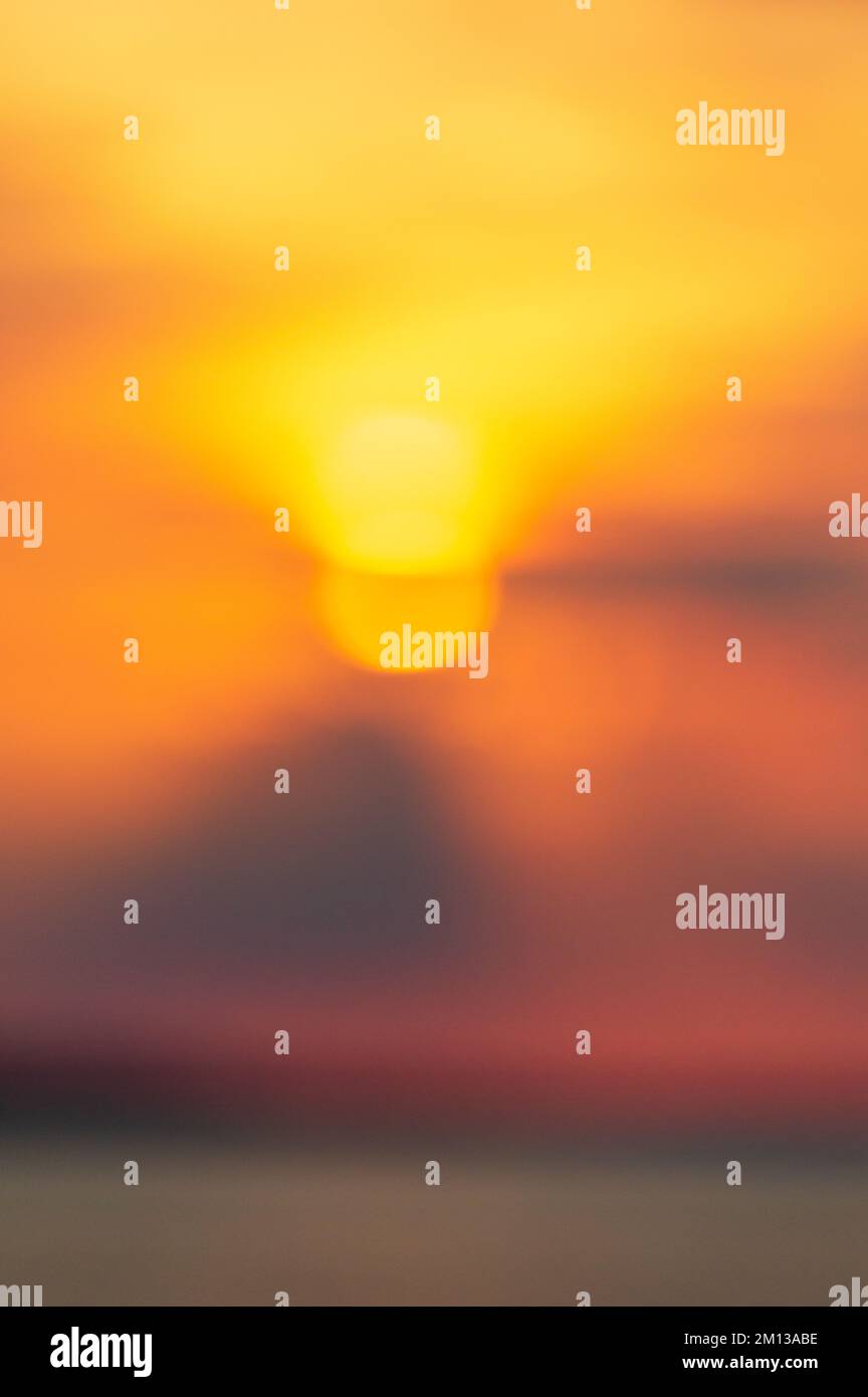 Blurred sun, orange dramatic light Stock Photo - Alamy