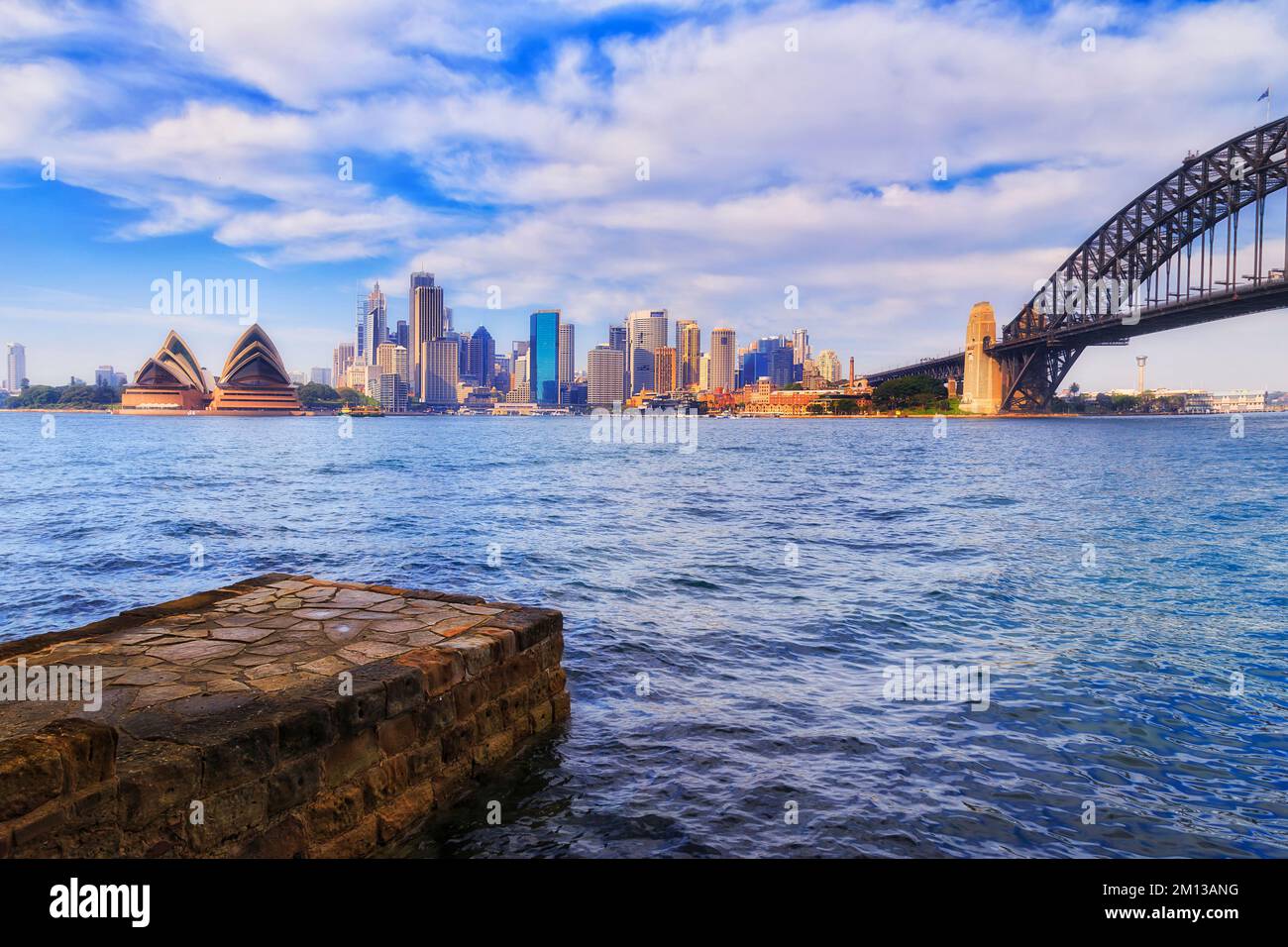 Stone pier on Sydney haroubr across Circular quay ferry terminal ...