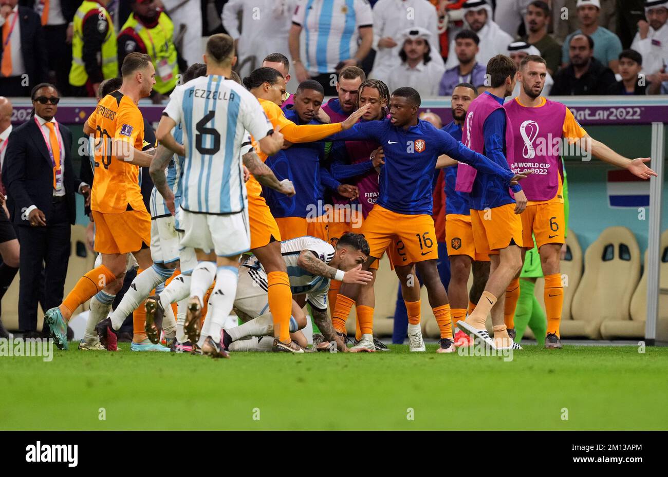 Argentina's Leandro Paredes on floor is surrounded by players after ...