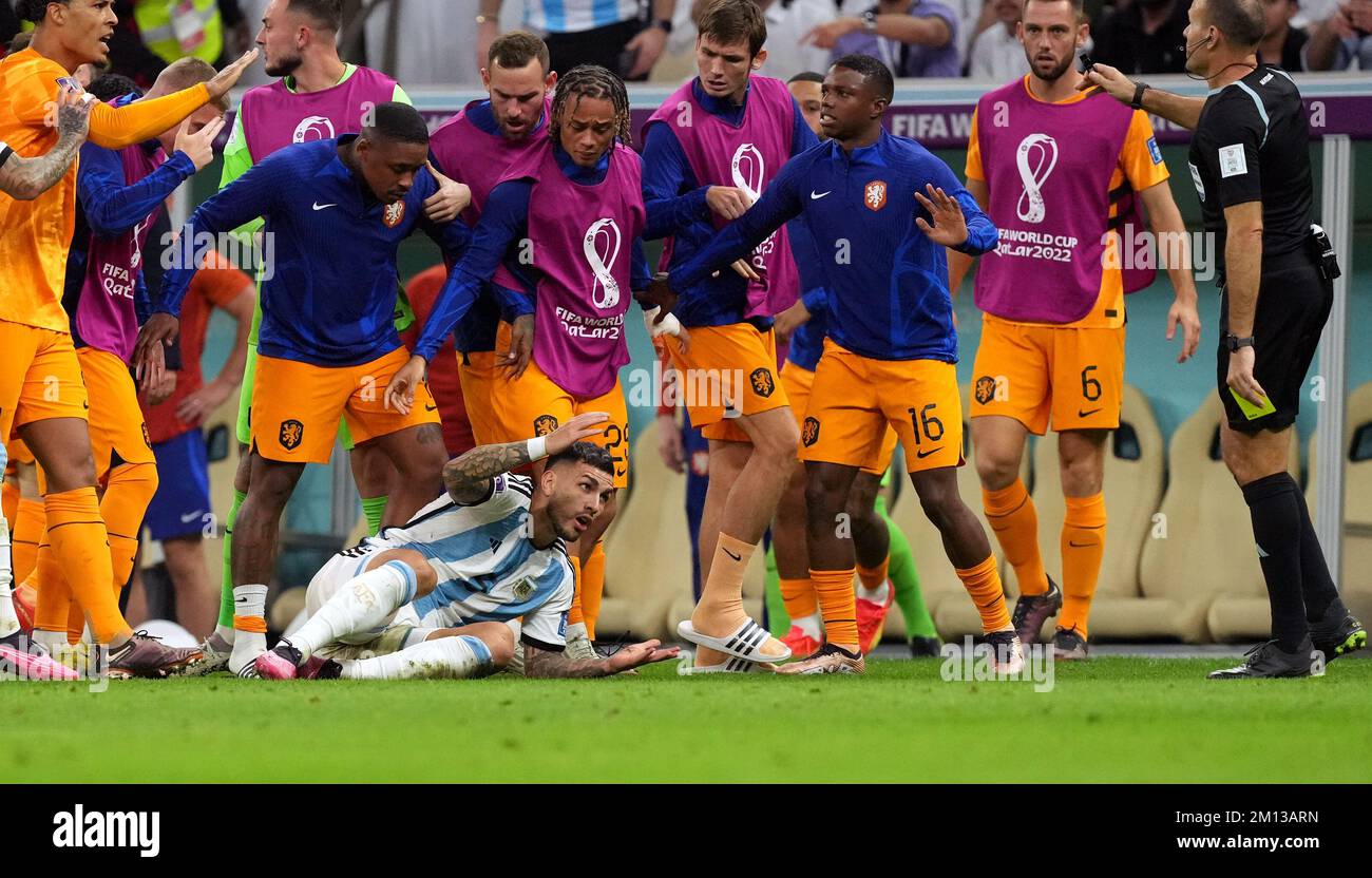 Argentina's Leandro Paredes on floor is surrounded by players after ...
