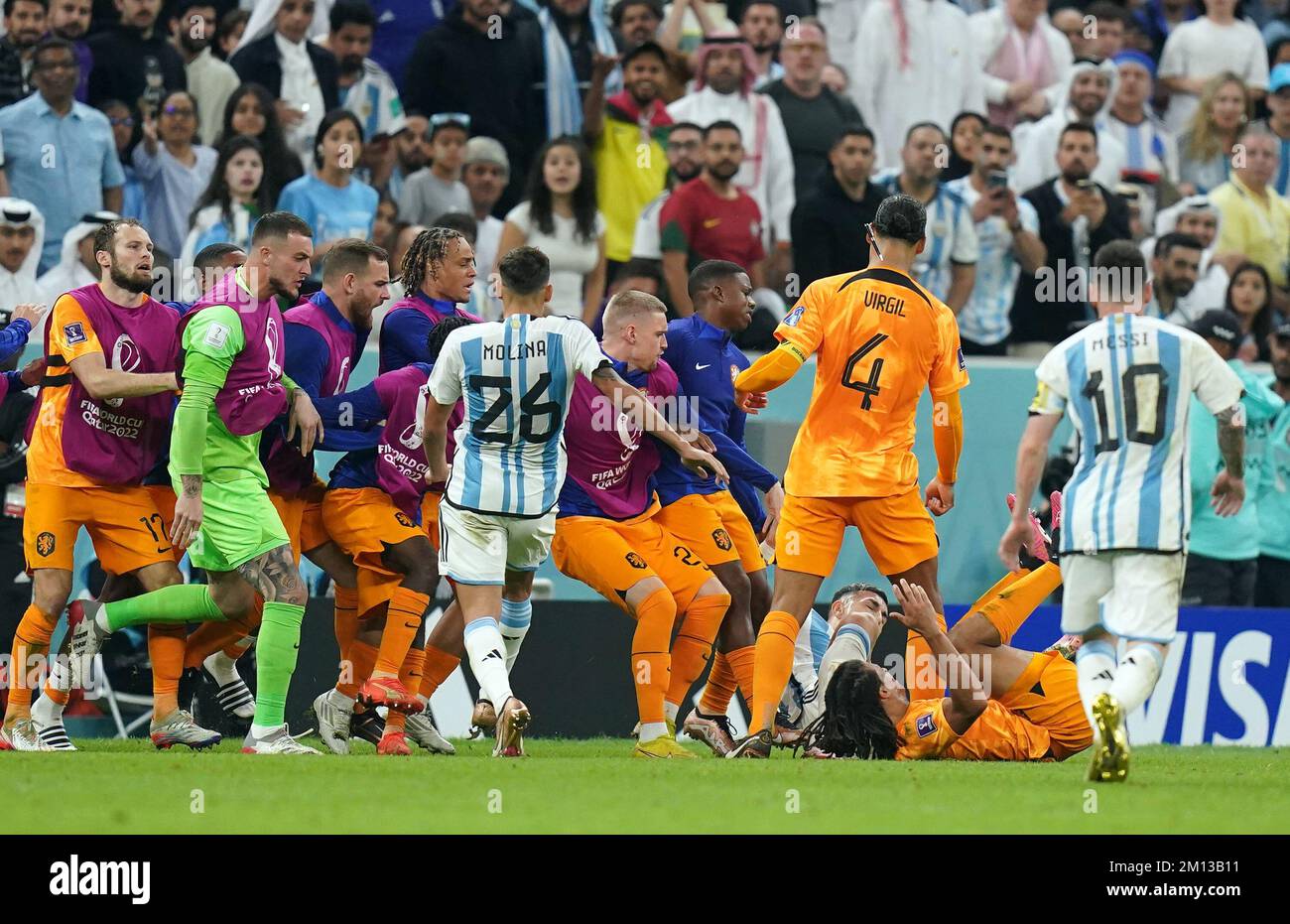 Argentina's Leandro Paredes (on floor, right) is surrounded by players ...