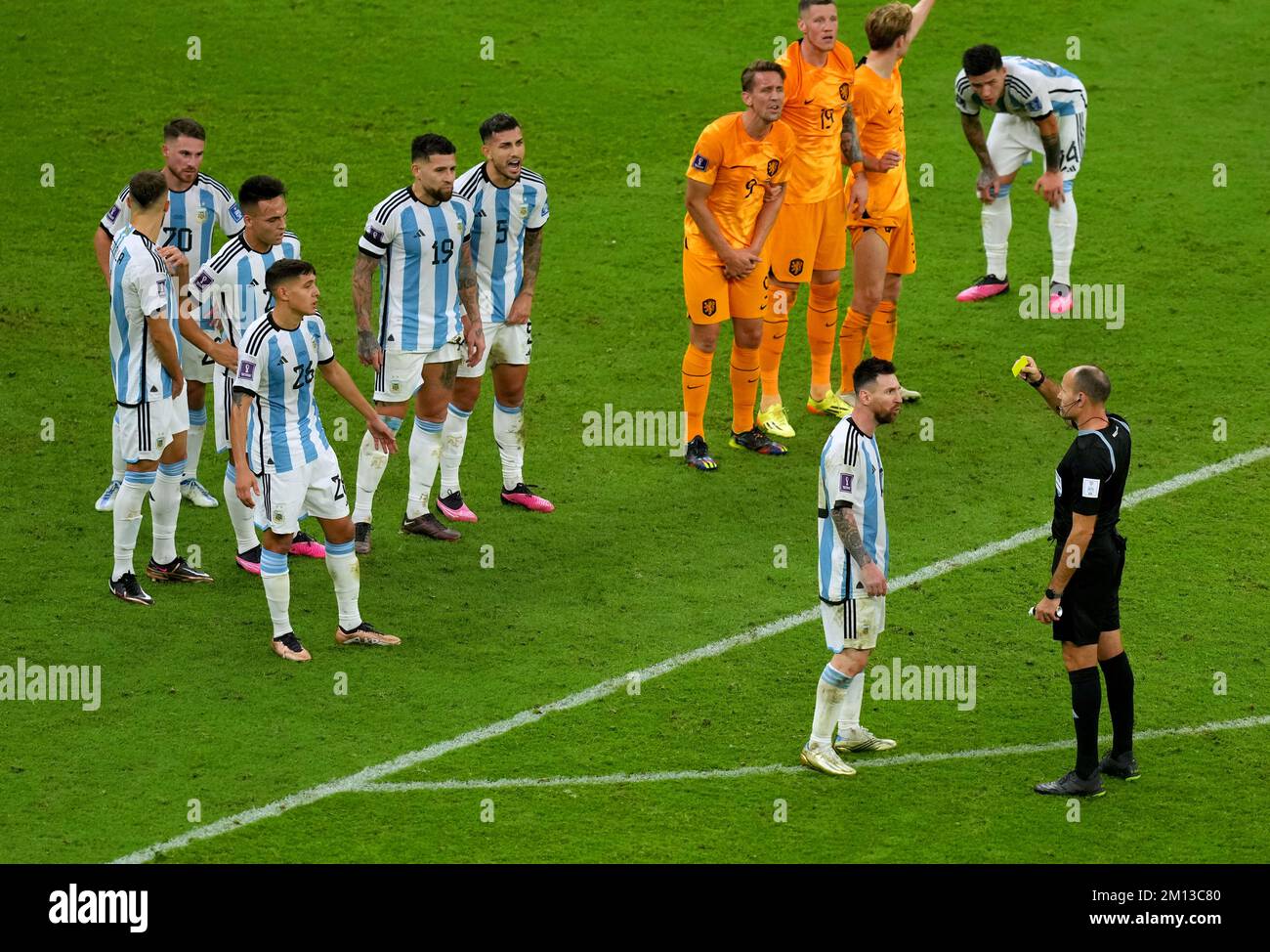 Argentina's Lionel Messi is shown a yellow card by referee Antonio Mateu Lahoz during the FIFA ...
