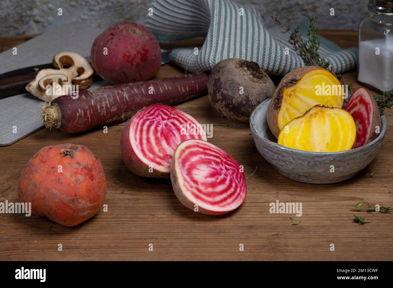 A rustic table with colorful beets carrots and dried mushrooms Stock ...