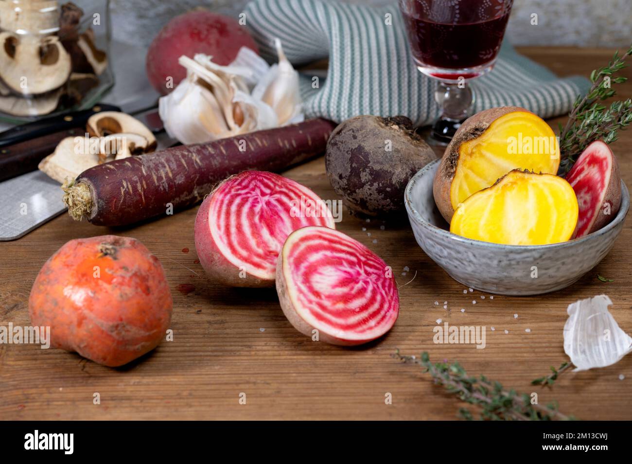 A rustic table with colorful beets carrots and dried mushrooms Stock ...
