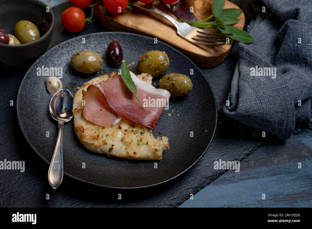 Antipasti plate with focaccia bread olives tomatoes and herbs Stock ...
