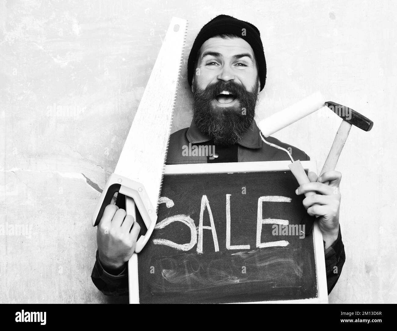 bearded foreman holding various building tools and board, happy face ...