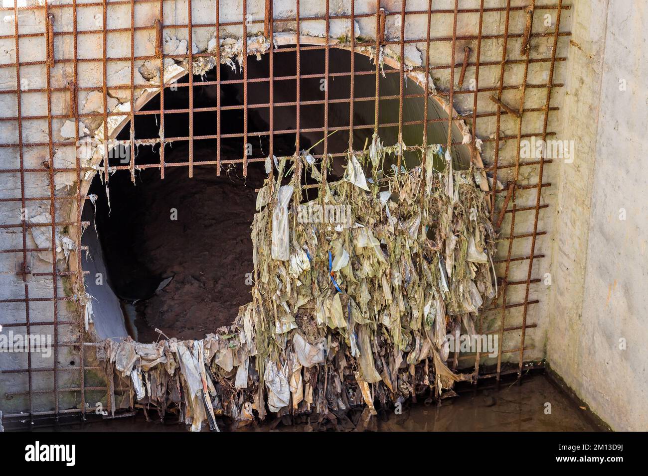 Storm sewer pipe closed with grating. Broken sewer entrance. Plastic ...