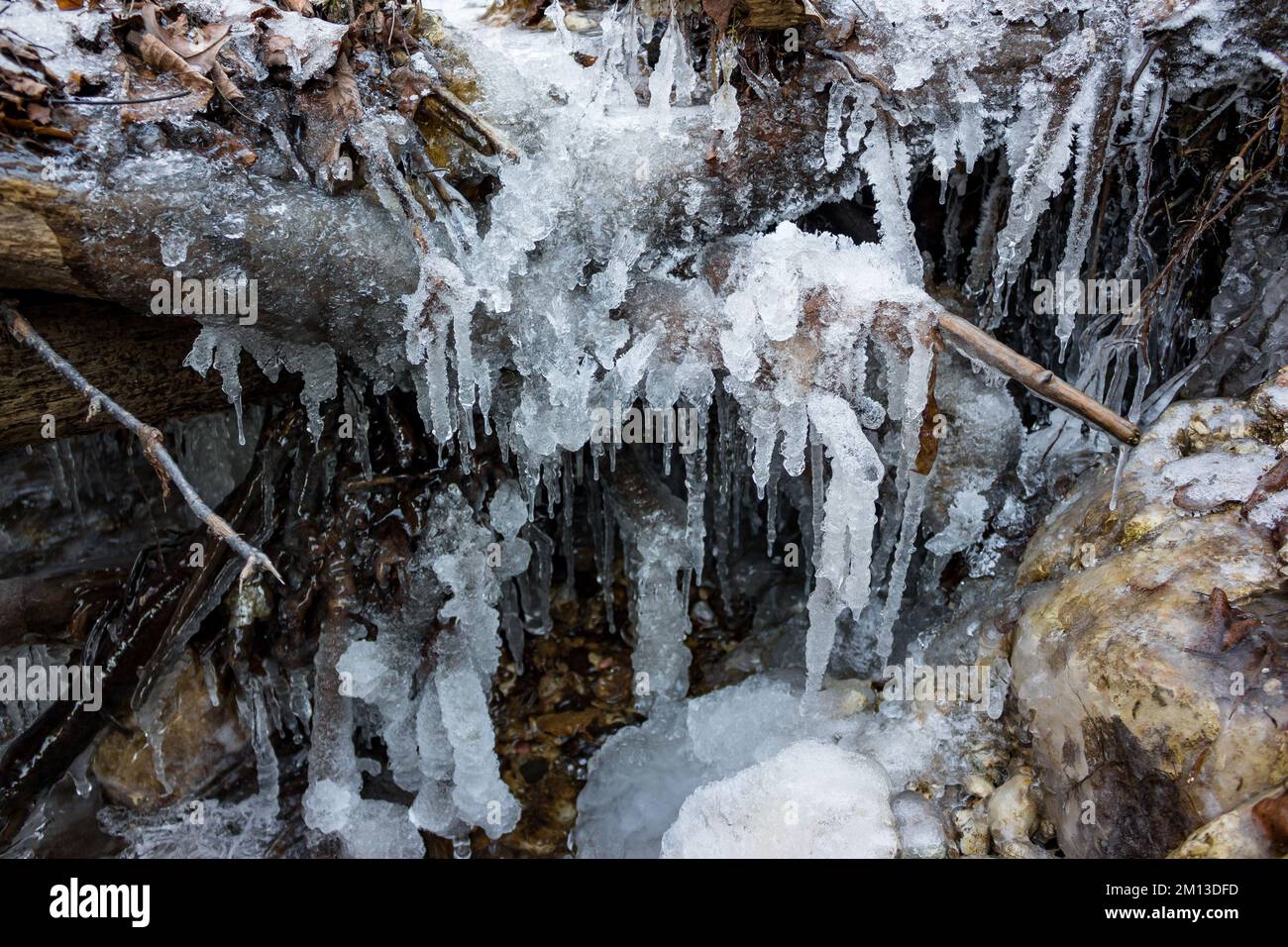 Icicles and powerful ice build-up on a stream in winter Stock Photo - Alamy