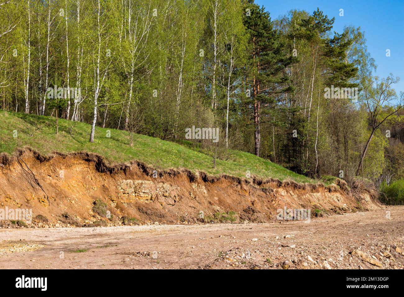 Cutting the soil cover with heavy machinery. Geological outcropping in ...