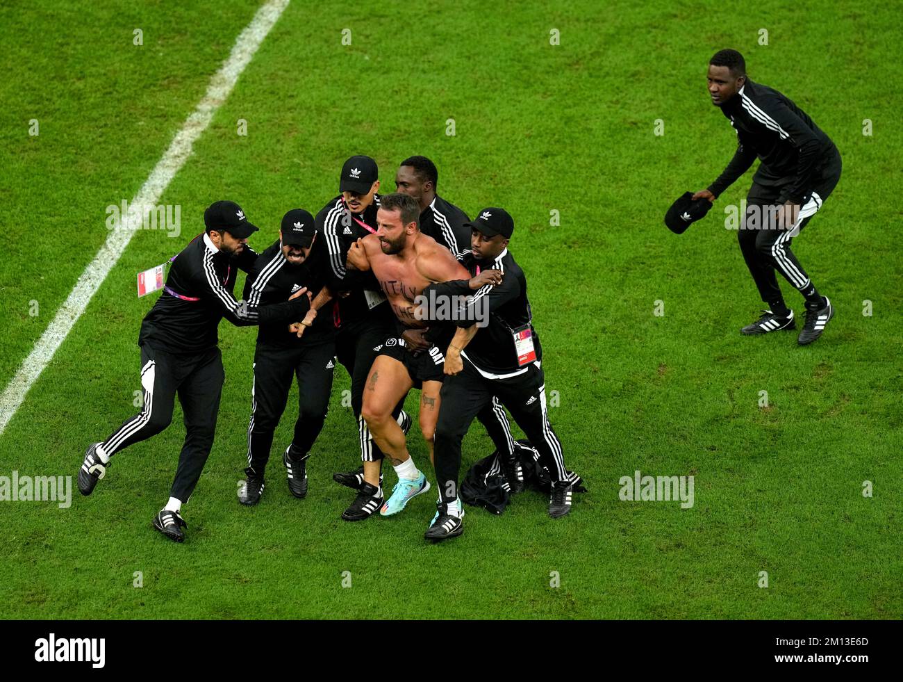Security remove a pitch invader during the FIFA World Cup Quarter-Final ...