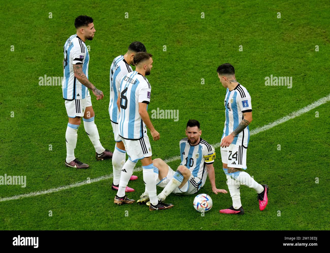 Argentina's Lionel Messi is surrounded by his team-mates as he sits on ...