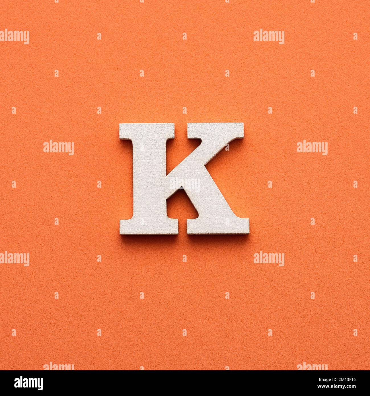 Letter K uppercase - white wooden font on pink background Stock Photo ...
