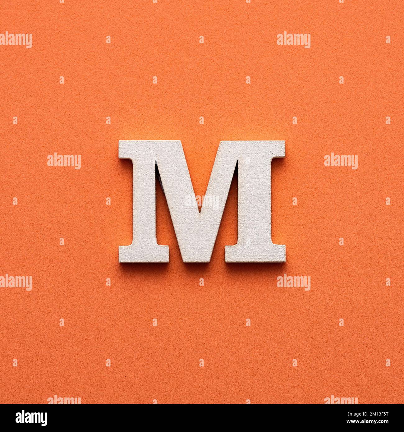 Letter M uppercase - white wooden font on pink background Stock Photo ...