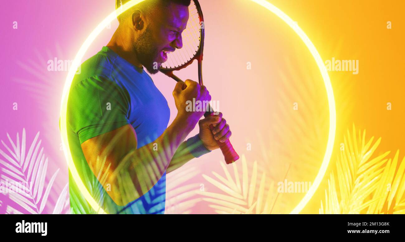 African american male tennis player holding racket screaming by ...