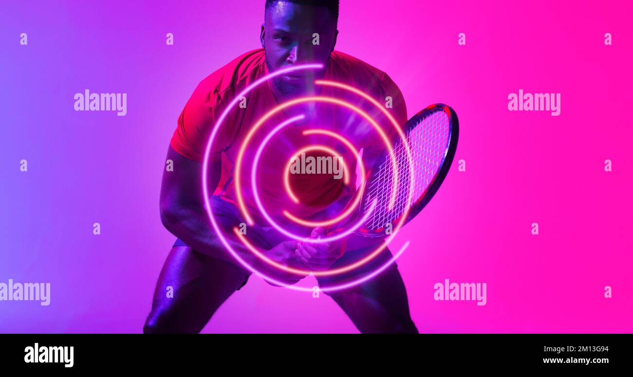 Illuminated circular pattern over african american tennis player ...