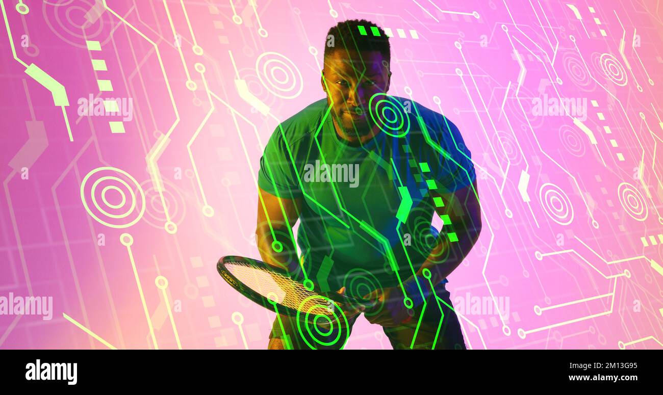 African american male tennis player holding racket over illuminated ...