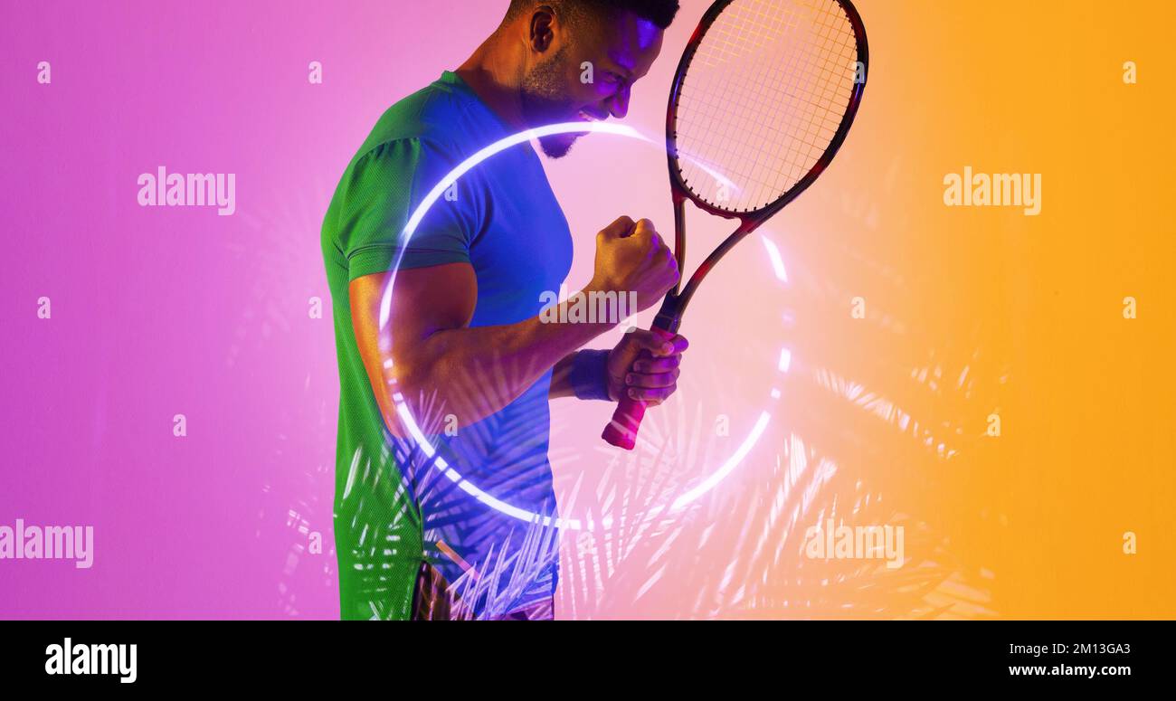 Side view of african american male player with racket shaking arms by ...