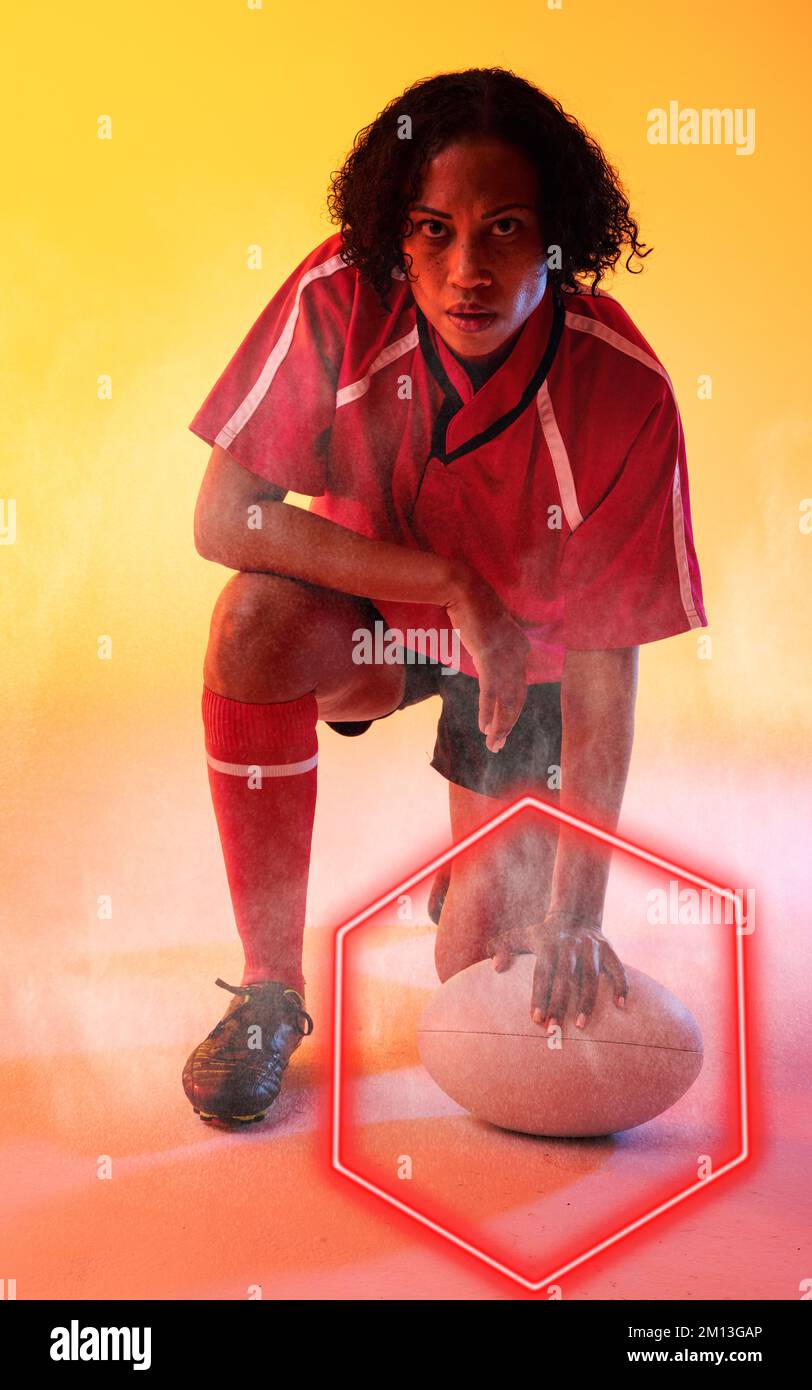 Composite of biracial female rugby player with ball bending by ...