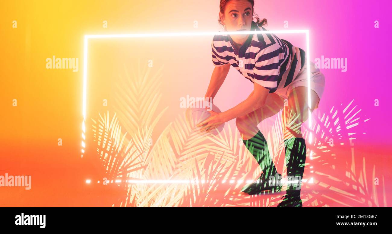 Caucasian female rugby player with ball bending over illuminated ...