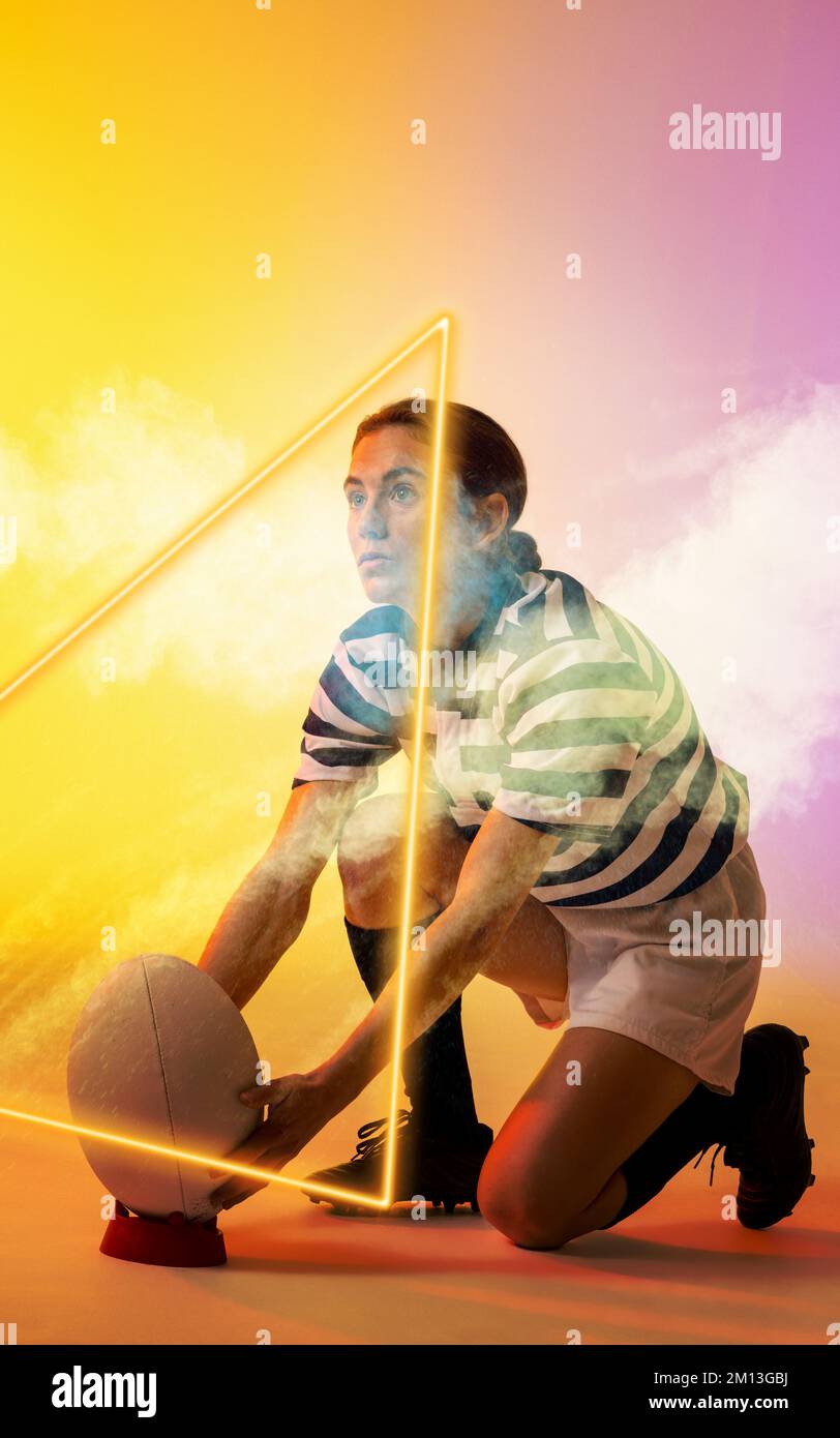 Illuminated triangle over caucasian female player placing rugby ball on ...