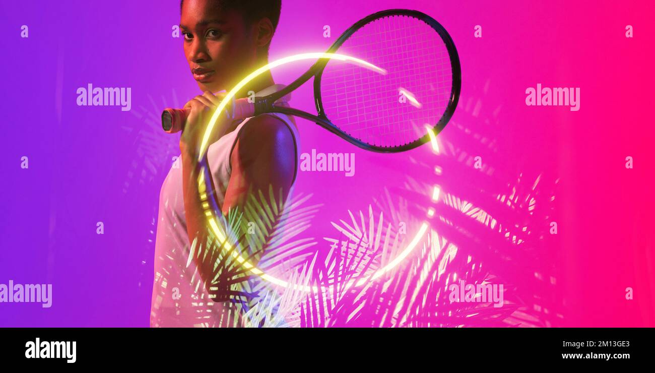 Side view of african american female tennis player with racket by ...