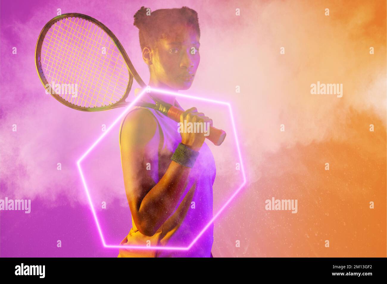 Confident african american female tennis player holding racket amidst ...