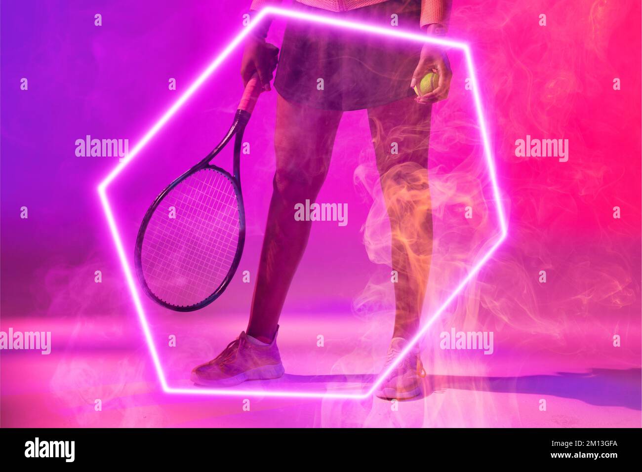 Low section of african american female tennis player holding ball and ...