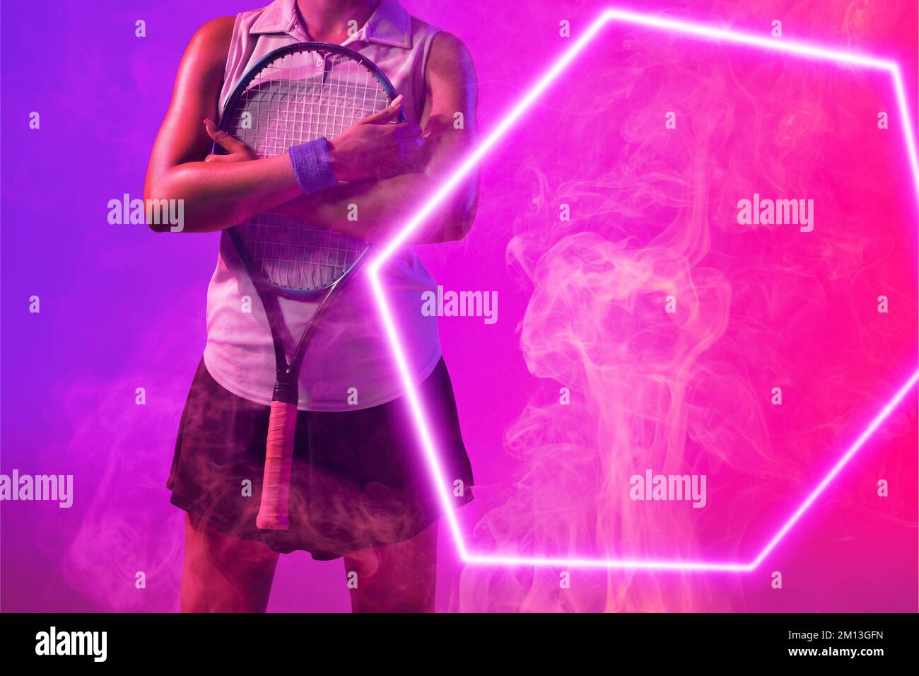 Midsection of african american female tennis player holding racket ...