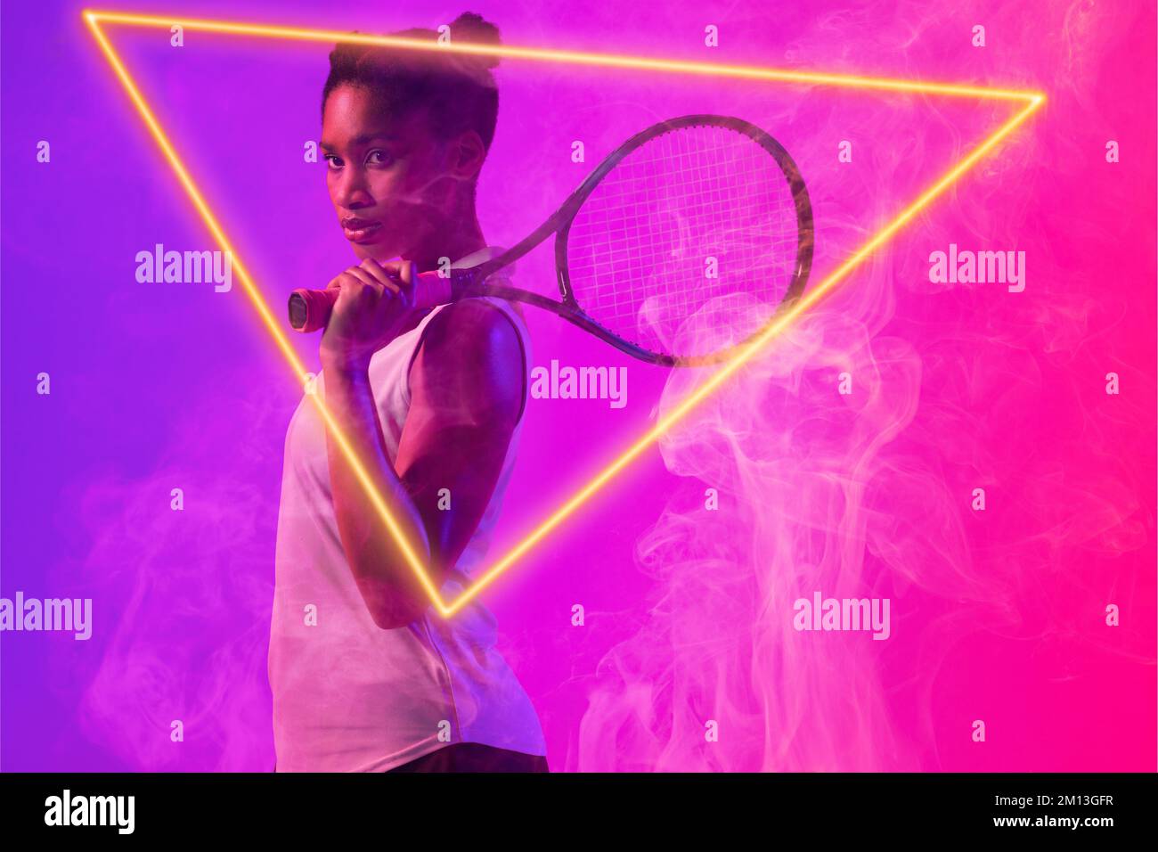 Side view of african american female tennis player holding racket by ...