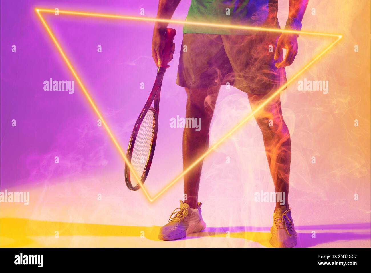 Low section of african american male tennis player with racket amidst ...