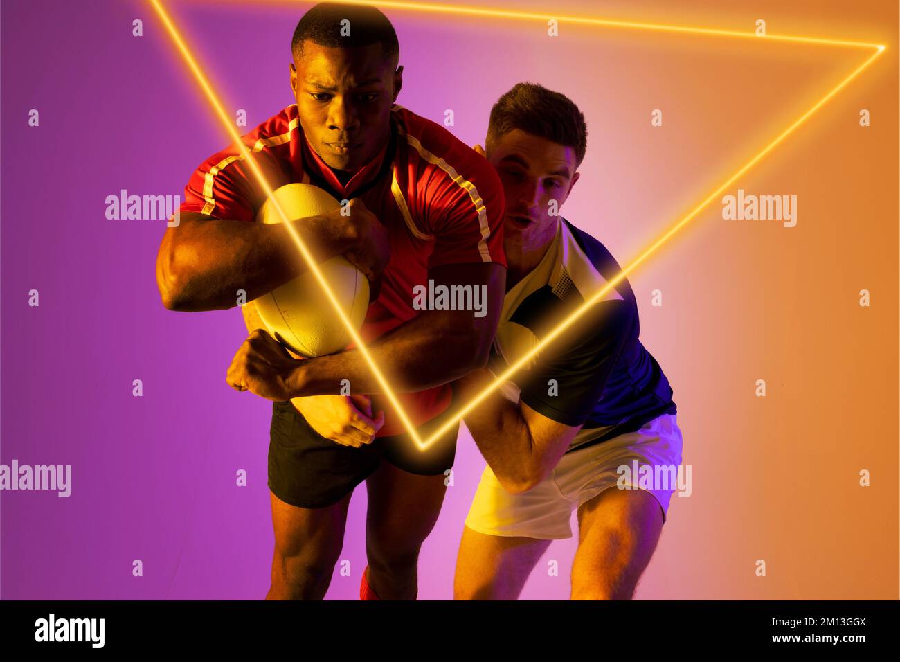 Multiracial rugby male opponents tackling ball by illuminated triangle ...