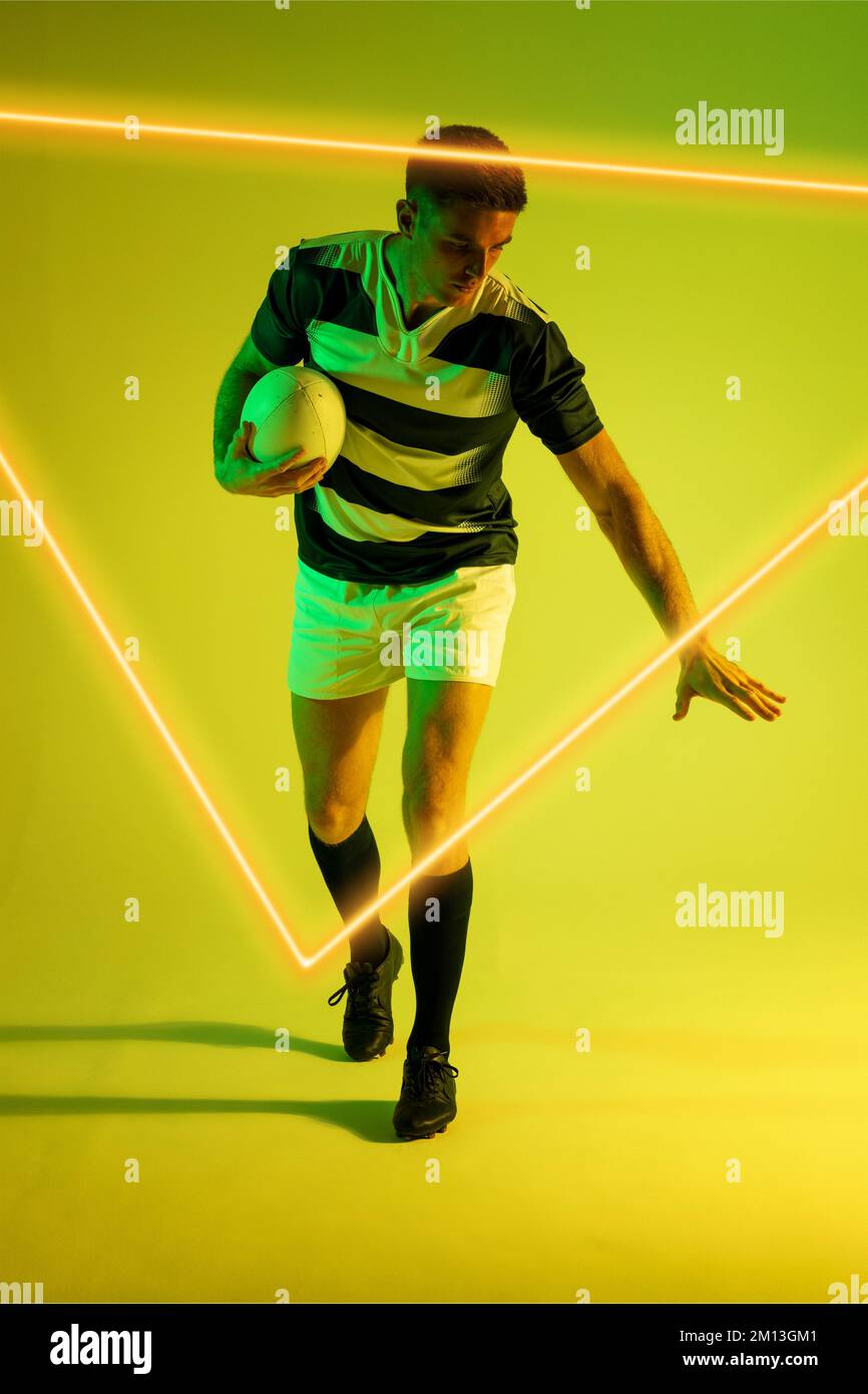 Illuminated triangle over caucasian male player with rugby ball ...